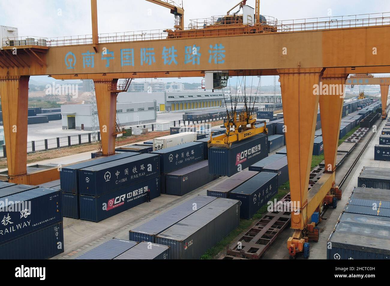 Nanning, China. 1st Jan, 2022. A gantry crane loads containers onto a ...