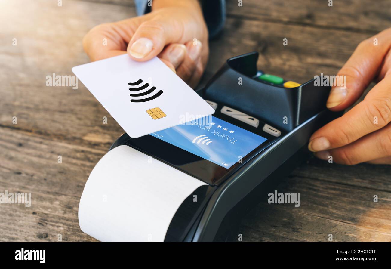 Contactless payment concept, female customer holding credit card near ...