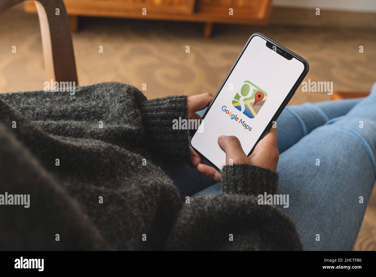 Woman Hand Holding Smartphone with Google Maps application o. Google ...