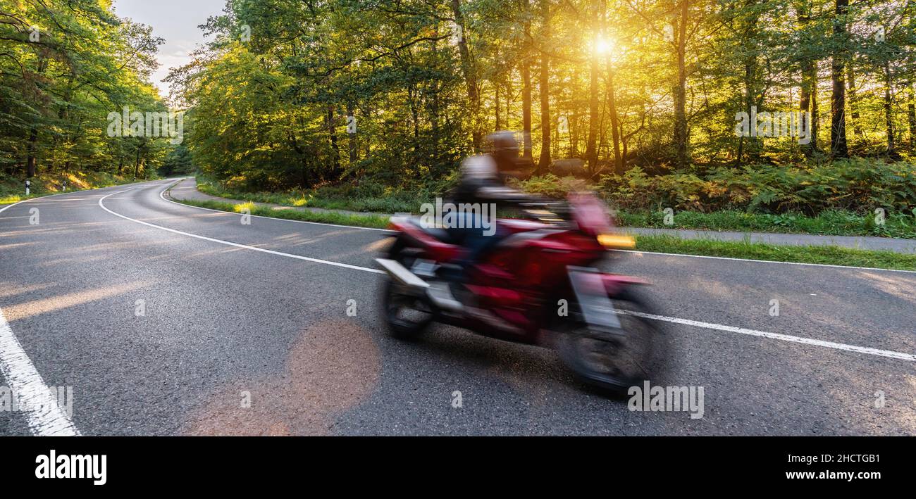 motorbike on the forest road riding fast. having fun driving the empty ...