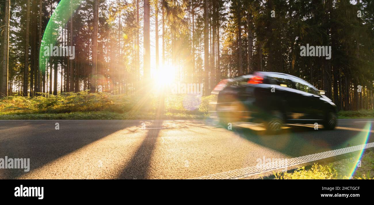 Long Forest Road with car In Alpine Mountains at sunset Stock Photo - Alamy