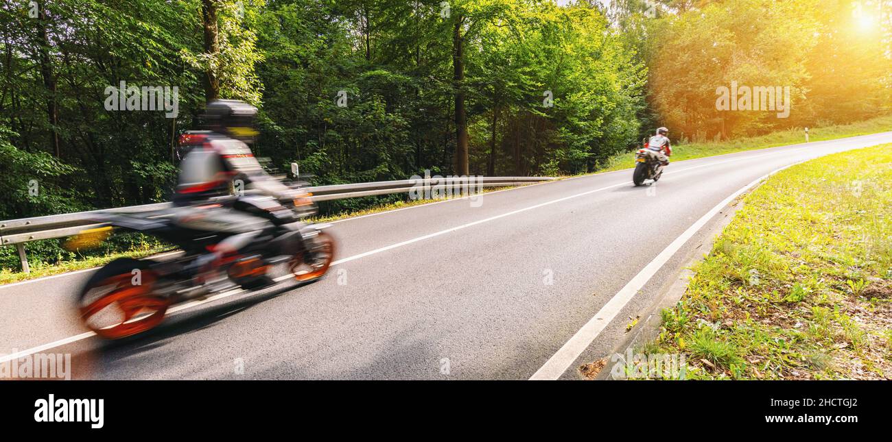 motorcycles on the forest road riding fast. having fun driving the ...