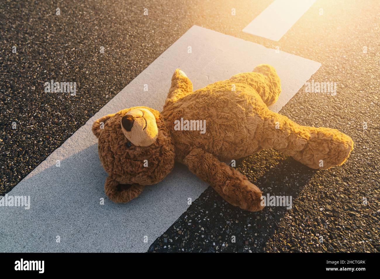 Lost teddy bear lying on the street after an accident Stock Photo - Alamy