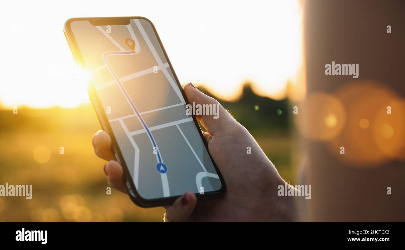 Tourist using GPS map navigation app on smartphone screen to get ...