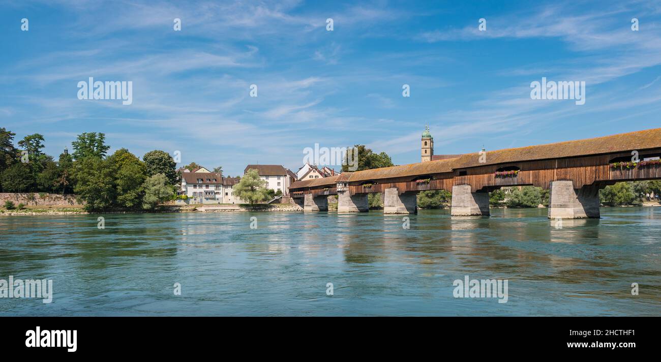 The historic wood border bridge over Rhine river and Fridolins minster ...