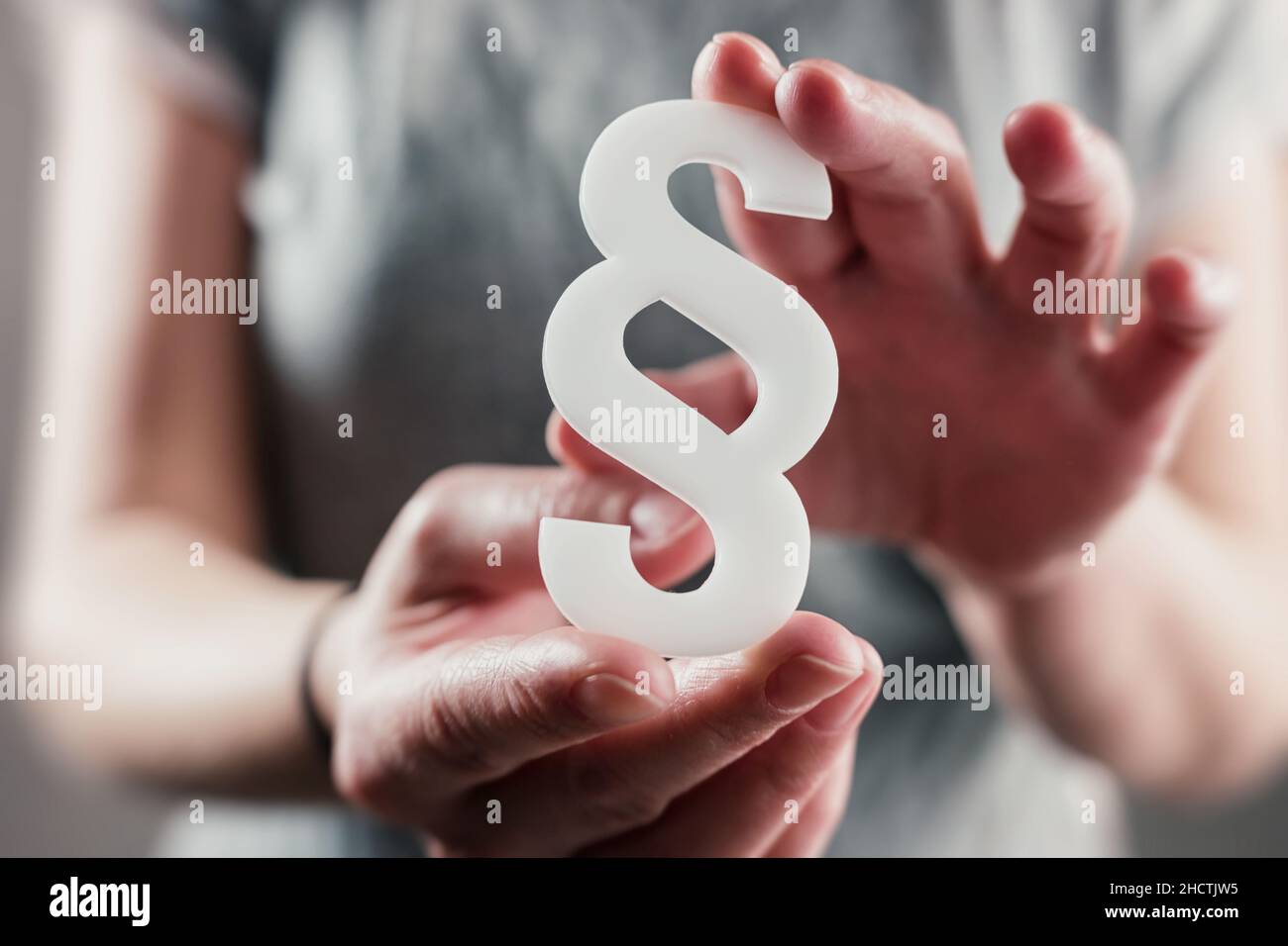 women holding a paragraph sign Stock Photo - Alamy