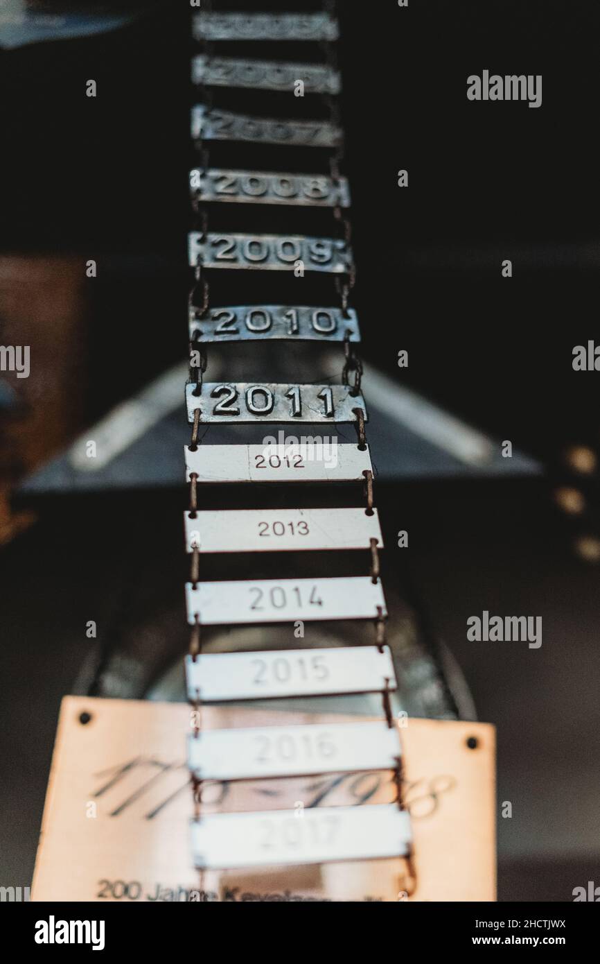 Vertical shot of a ribbon with metal labels of years Stock Photo - Alamy