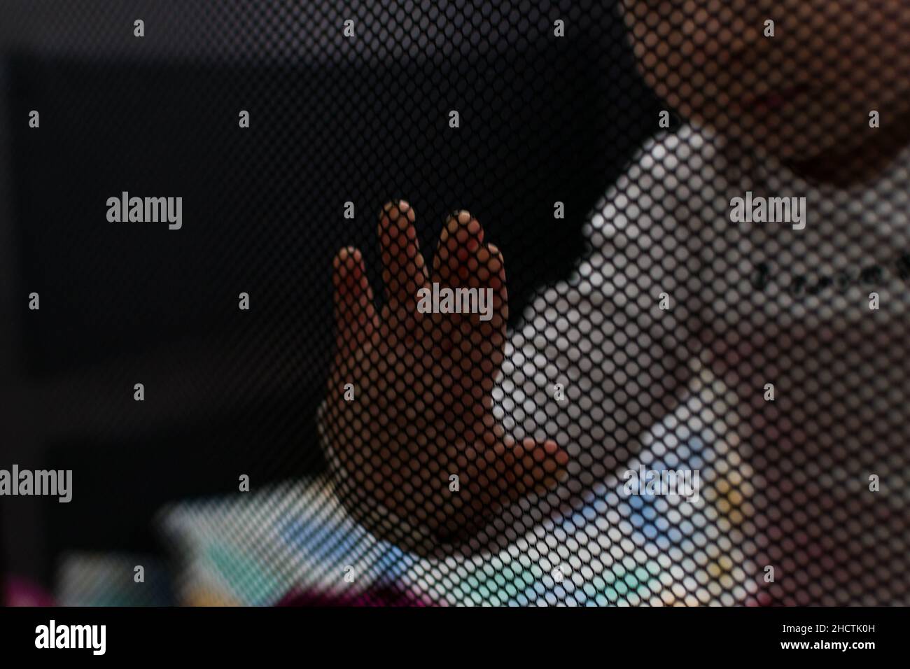 Baby hand touching safety net, close up Stock Photo - Alamy