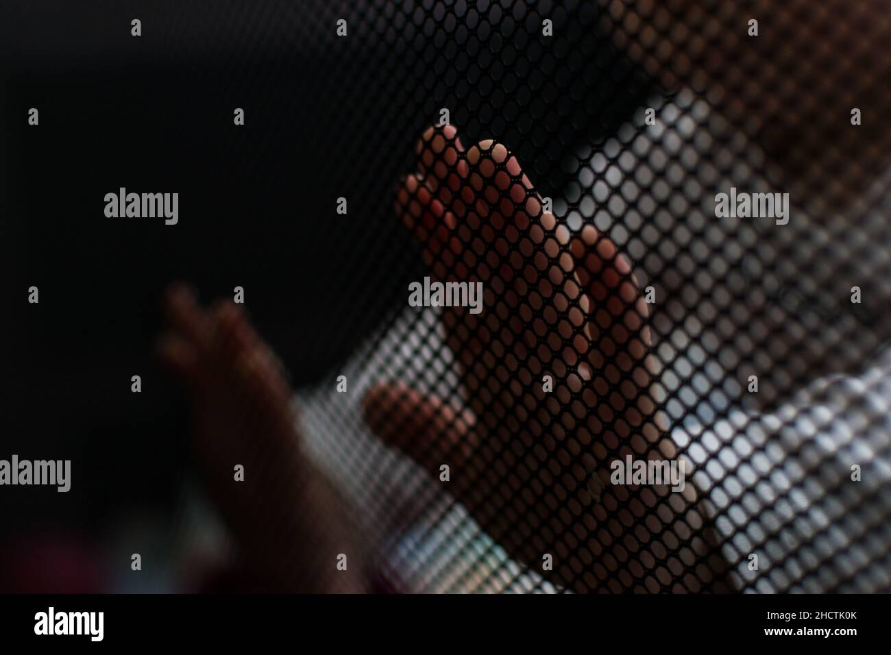 Close up of baby hands touching safety net Stock Photo - Alamy