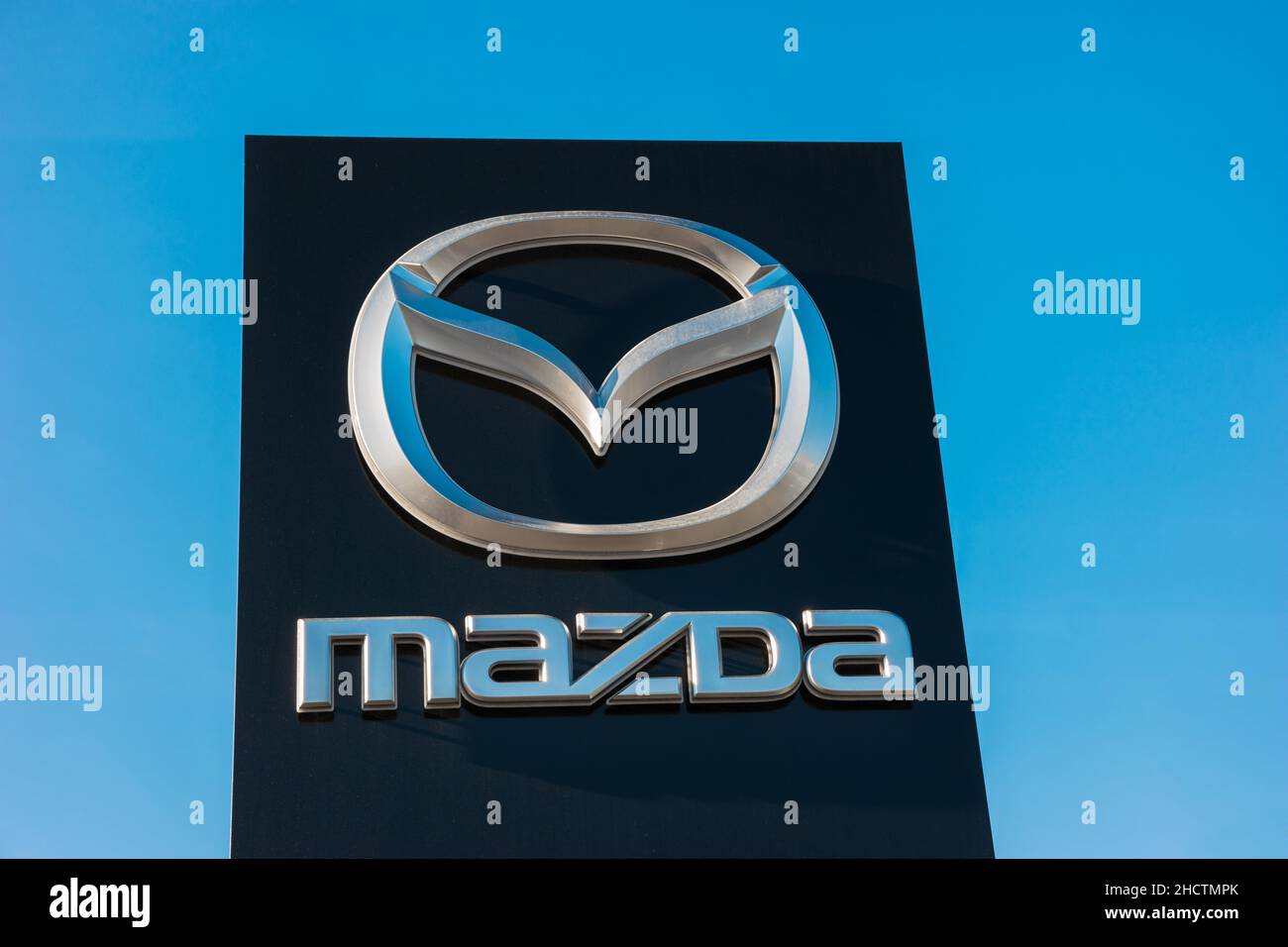 Mazda dealership sign against blue sky. Mazda is a Japanese automaker ...
