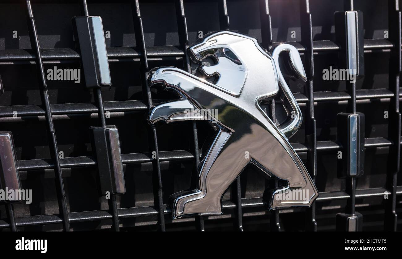 Peugeot logo sign on a car grill. Peugeot is a French cars brand, part ...
