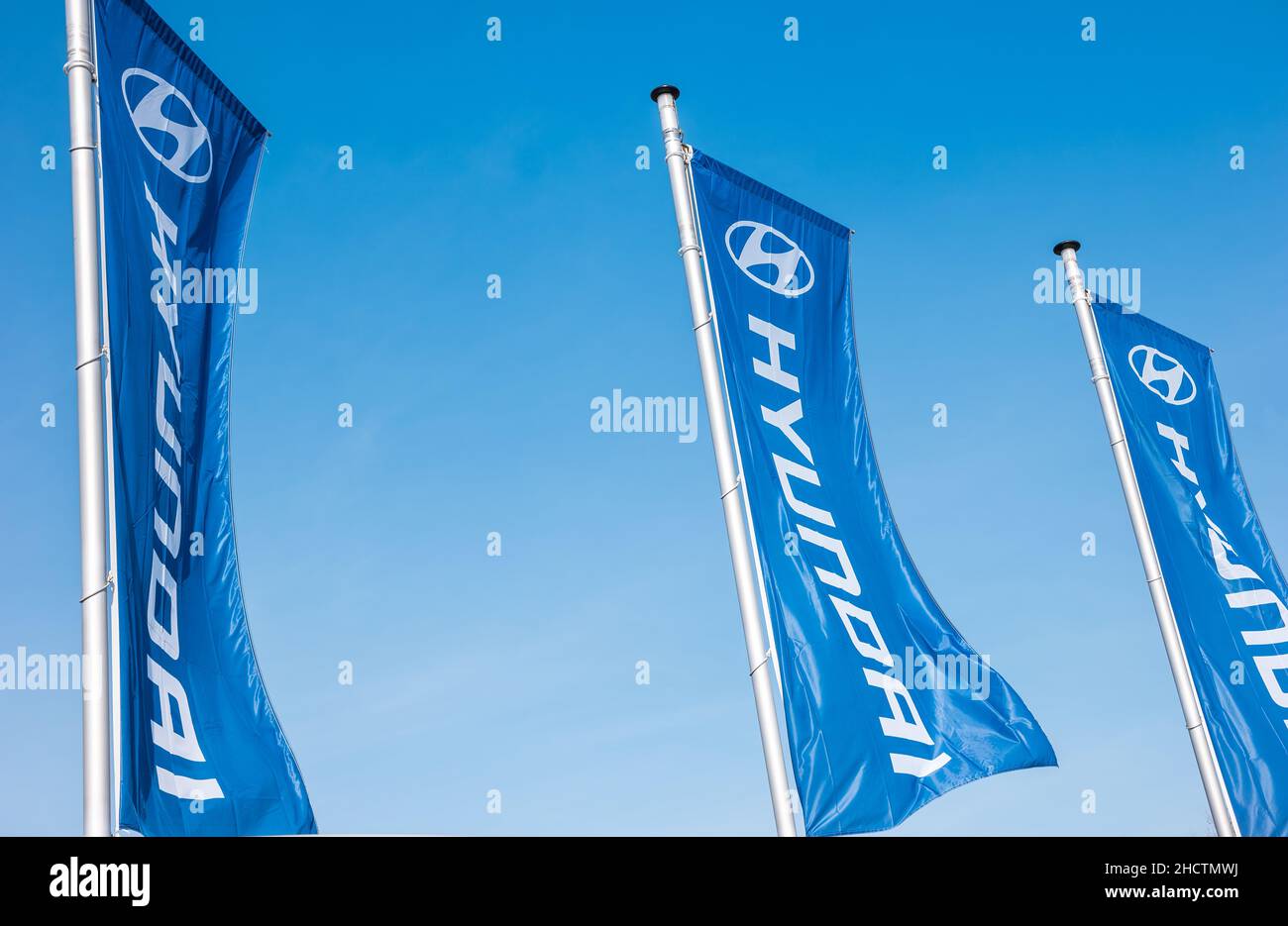 Hyundai flags against blue sky. Hyundai Motor Company is a South Korean ...