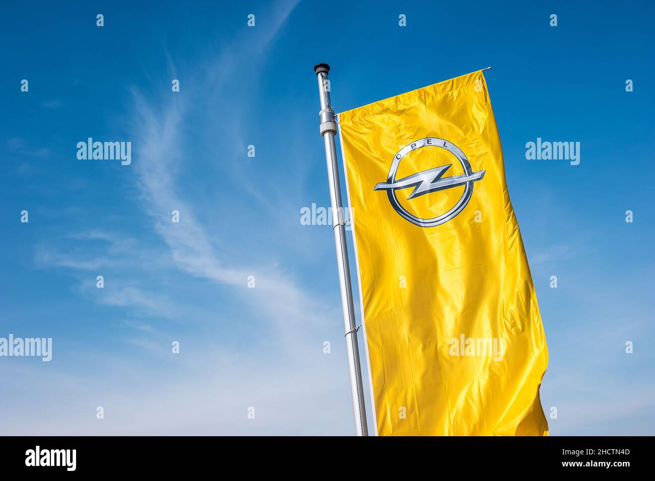Opel flag against blue sky at the Opel Store. Opel AG is a German ...