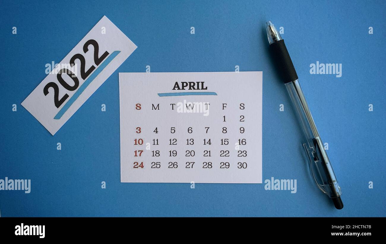 White April 2022 calendar with pen and blue background. 2022 New Year ...