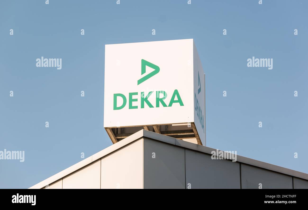 Dekra logo on a building. Dekra is a vehicle inspection company founded ...