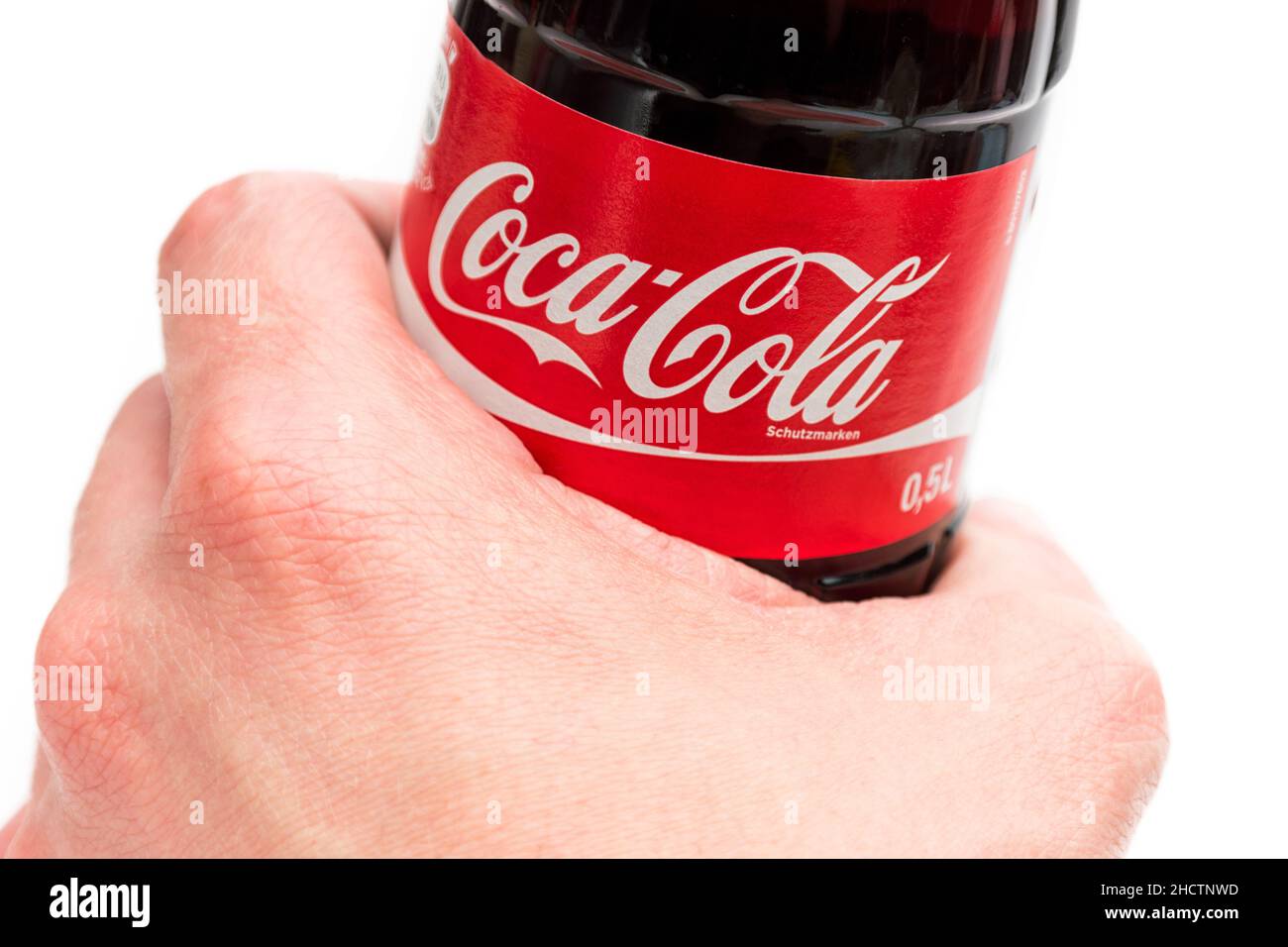 Hand hold a bottle Coca-Cola on white background. Coca Cola drinks are ...