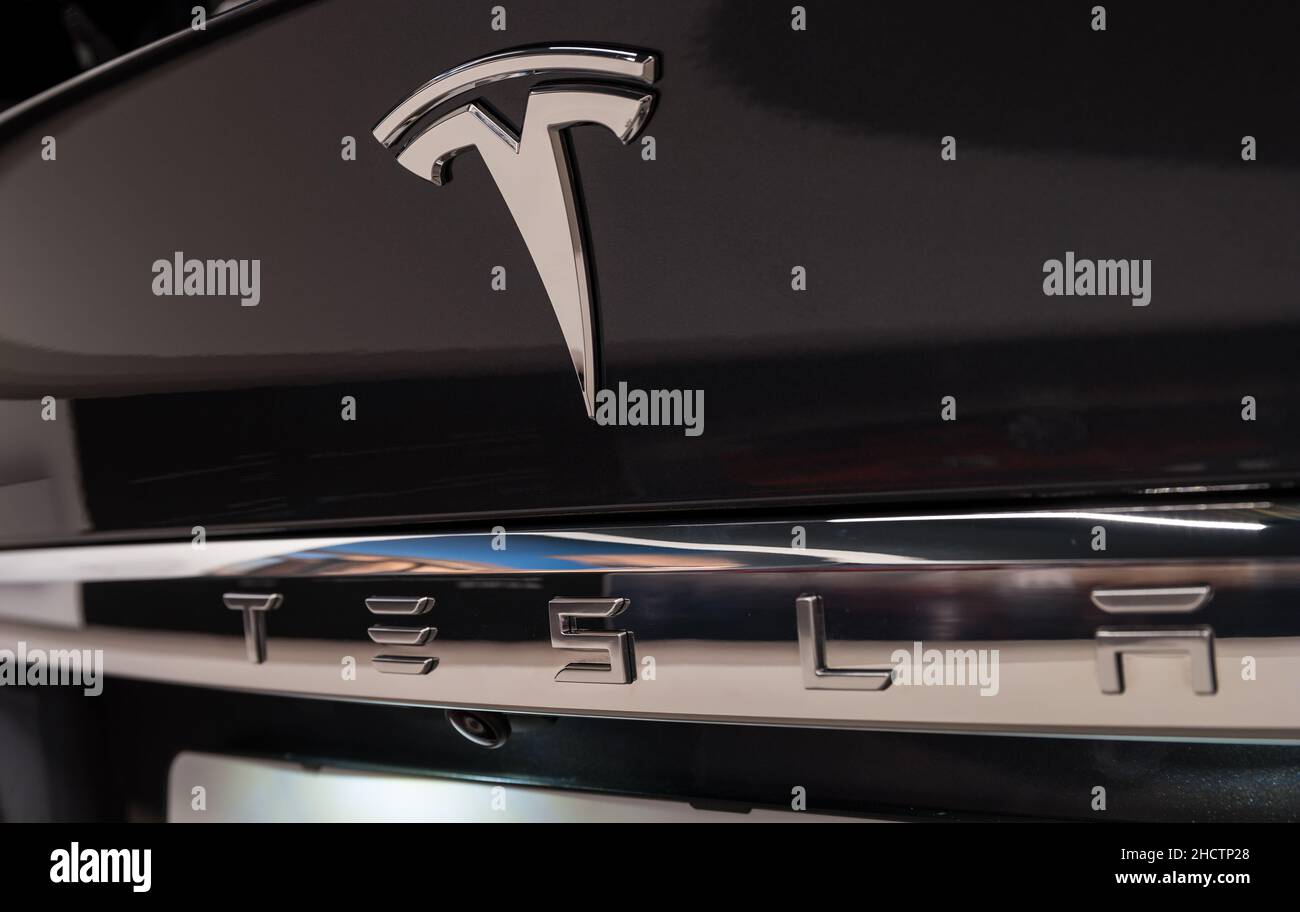 Tesla Logo on a black car. Tesla Motors, Inc. is an American automotive ...