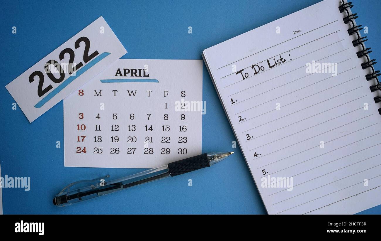 White April 2022 calendar with to do list text written on notepad. 2022 ...