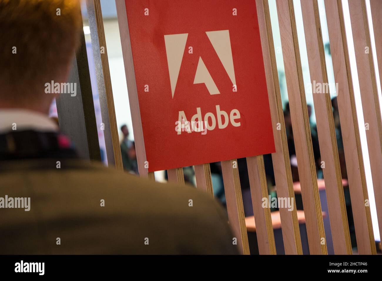 Adobe Systems Logo with business man. Adobe is a multinational software ...