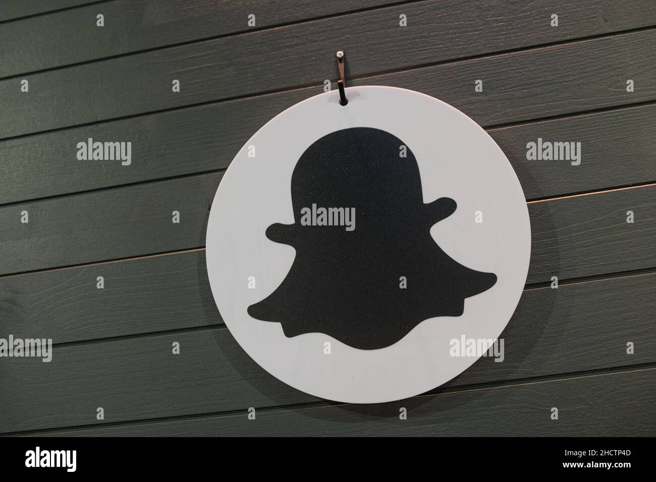 Snapchat logo on a wall. Snapchat is a popular social media application ...