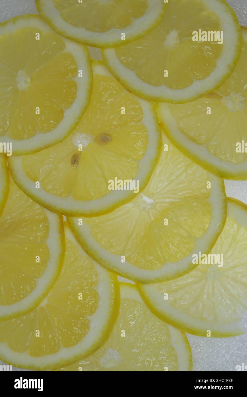 Lemon slices lined up close-up. Acid citrus fruit arranged for ...