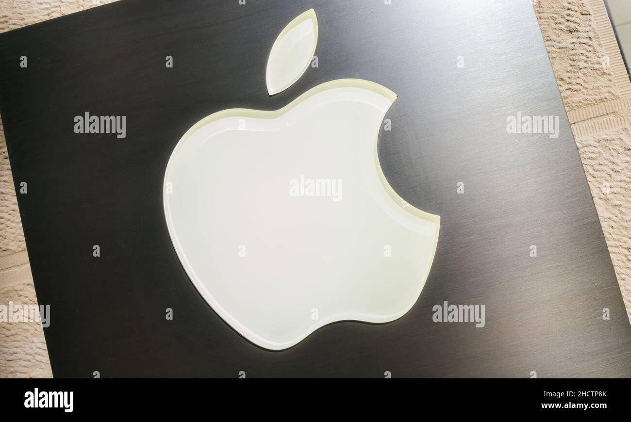 Apple sign on the Apple store. Apple Inc. is an American multinational ...