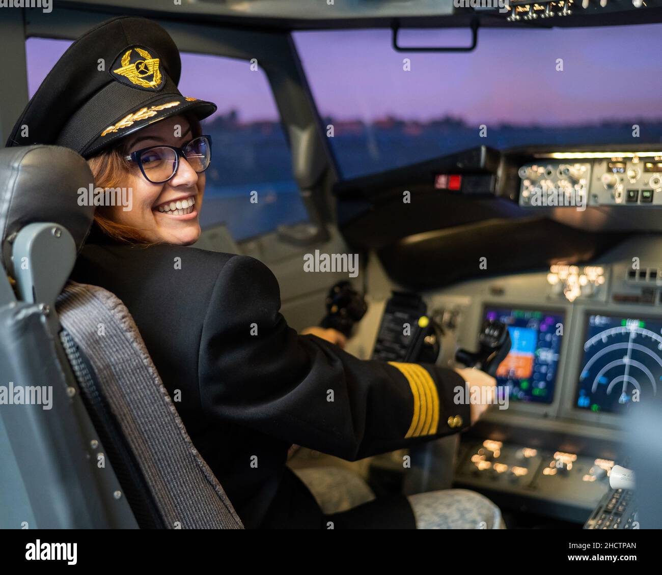 Female pilot on board the aircraft. Caucasian woman in flight simulator ...
