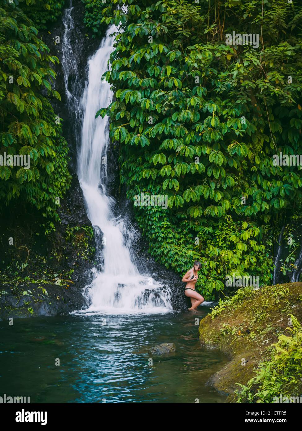 Waterfall with woman in bikini and tropical nature at Bali, Indonesia ...