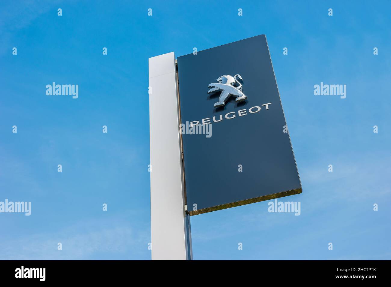 Peugeot dealership sign against blue sky. Peugeot is a French ...