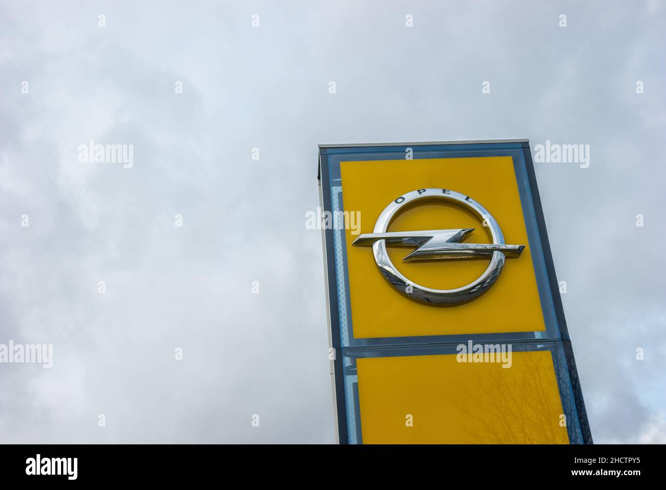 Opel official dealership logo over cloudy Sky. Opel AG is a German ...