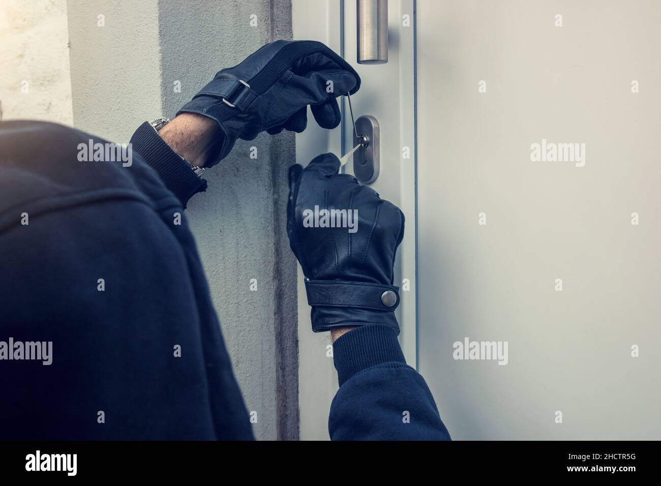 burglar holding Lock-picker to open a housedoor Stock Photo - Alamy