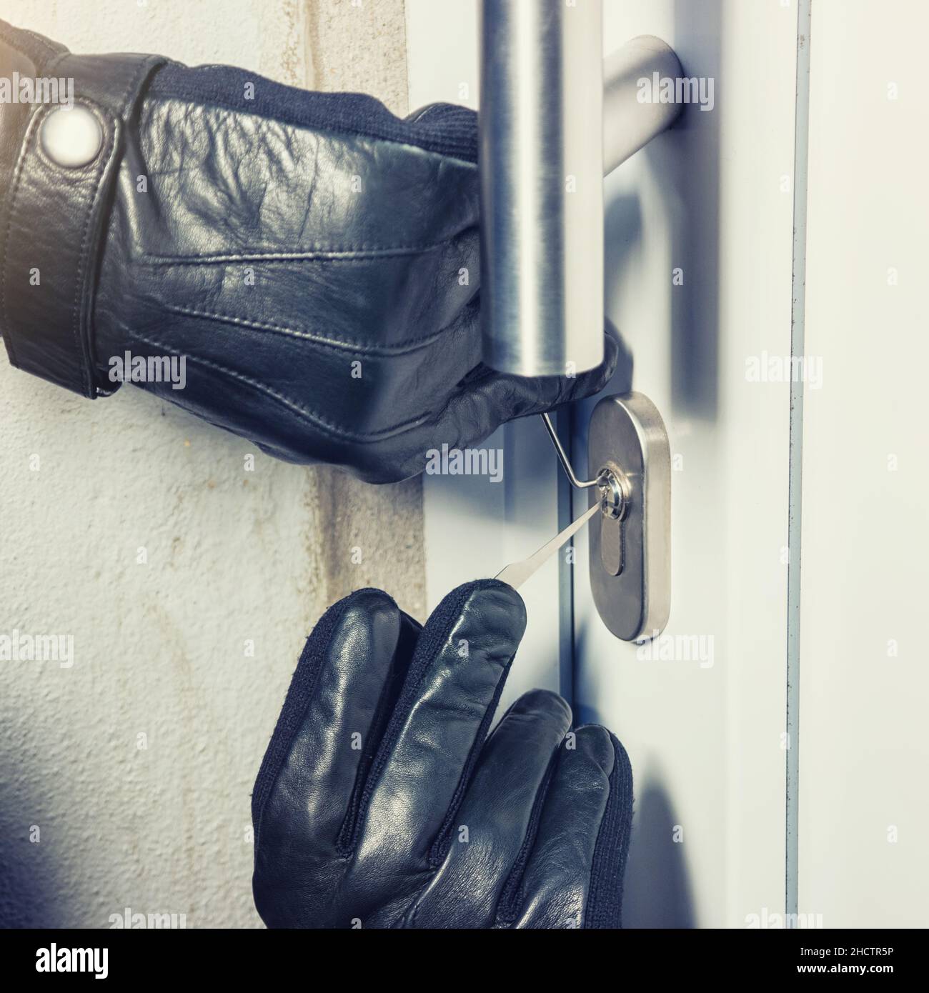 burglar holding Lock-picker to open a housedoor Stock Photo - Alamy