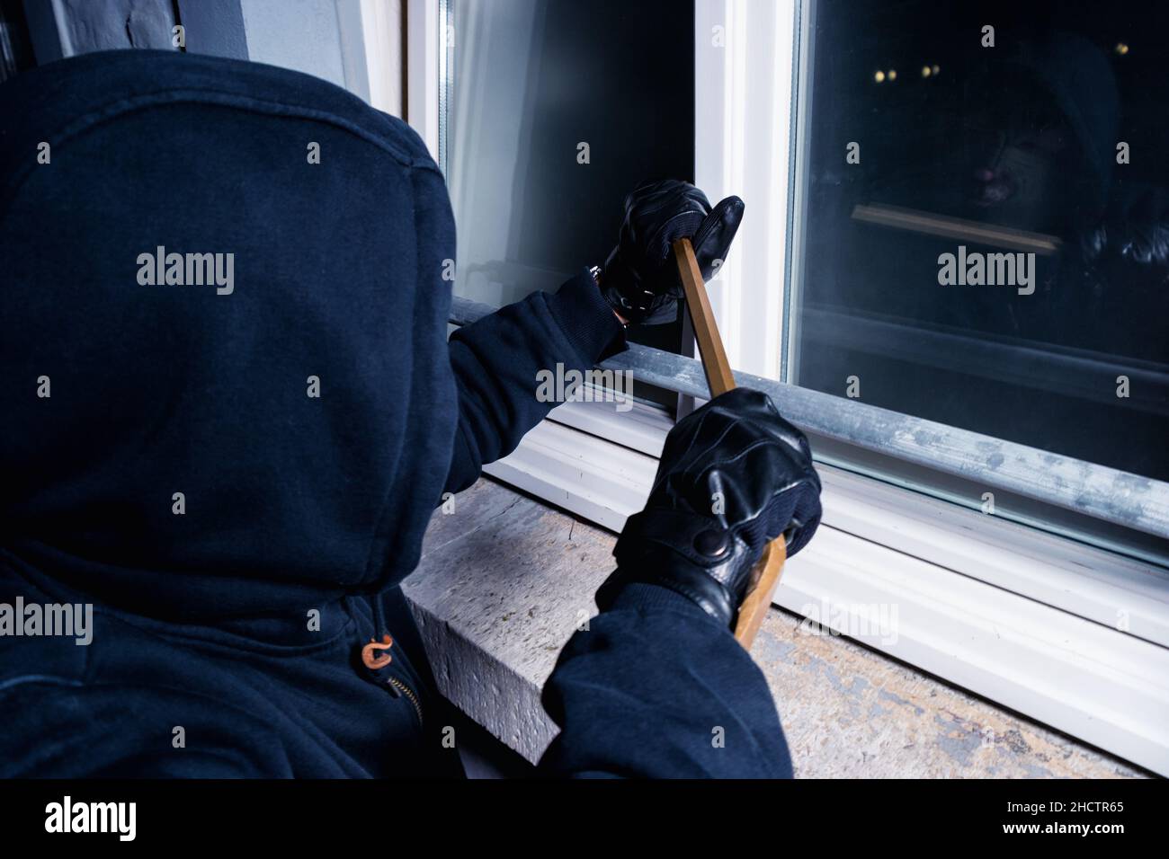 burglar opens a window with a crowbar at night Stock Photo - Alamy