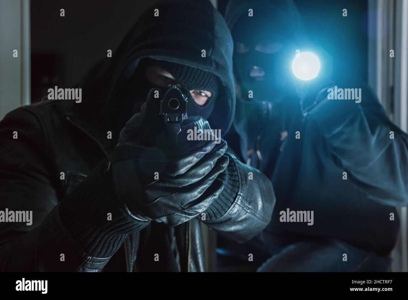 Two Burglar trying to break into a house with a Gun Stock Photo - Alamy