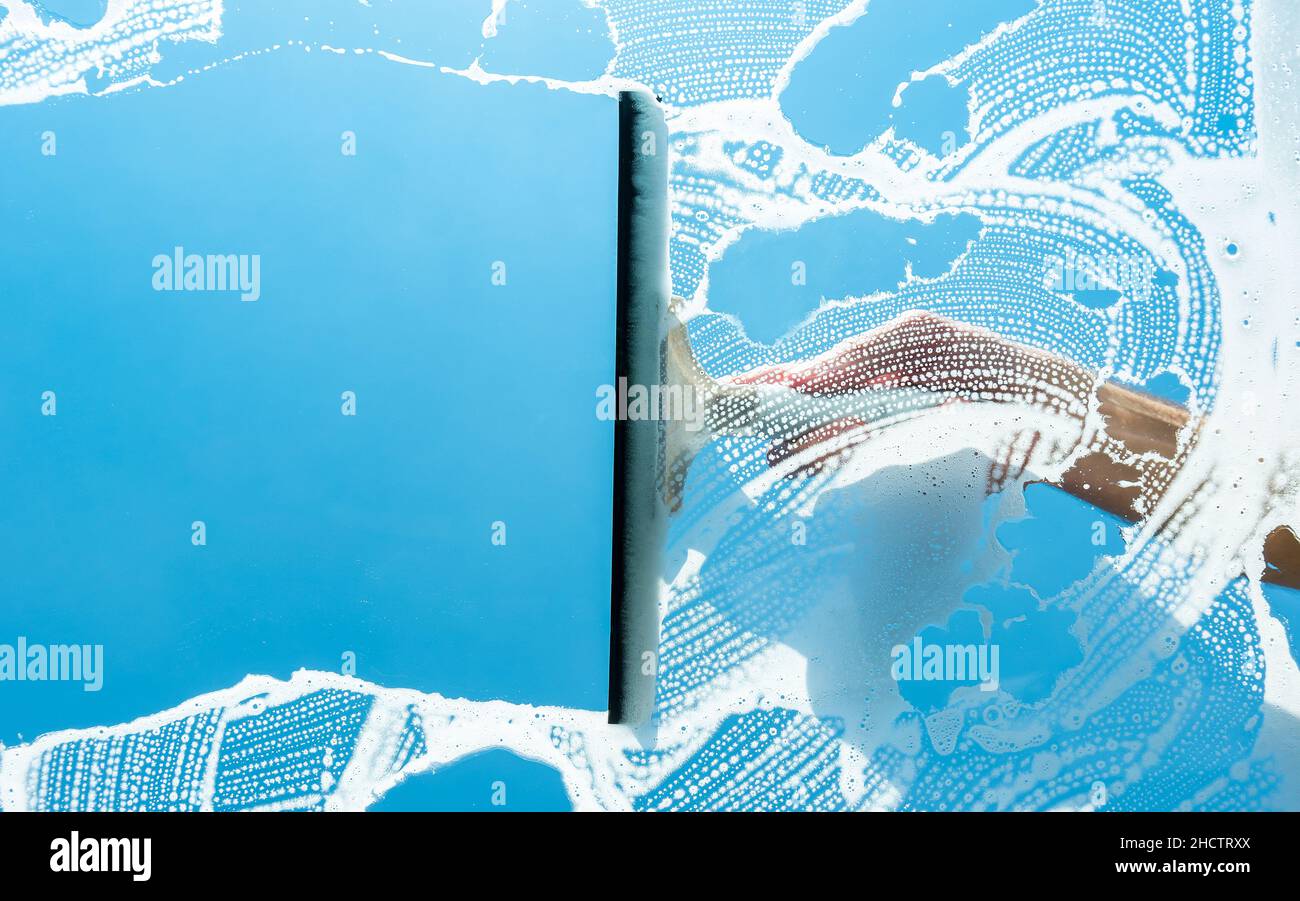 man cleaning window squeegee spray with squeegee Stock Photo - Alamy