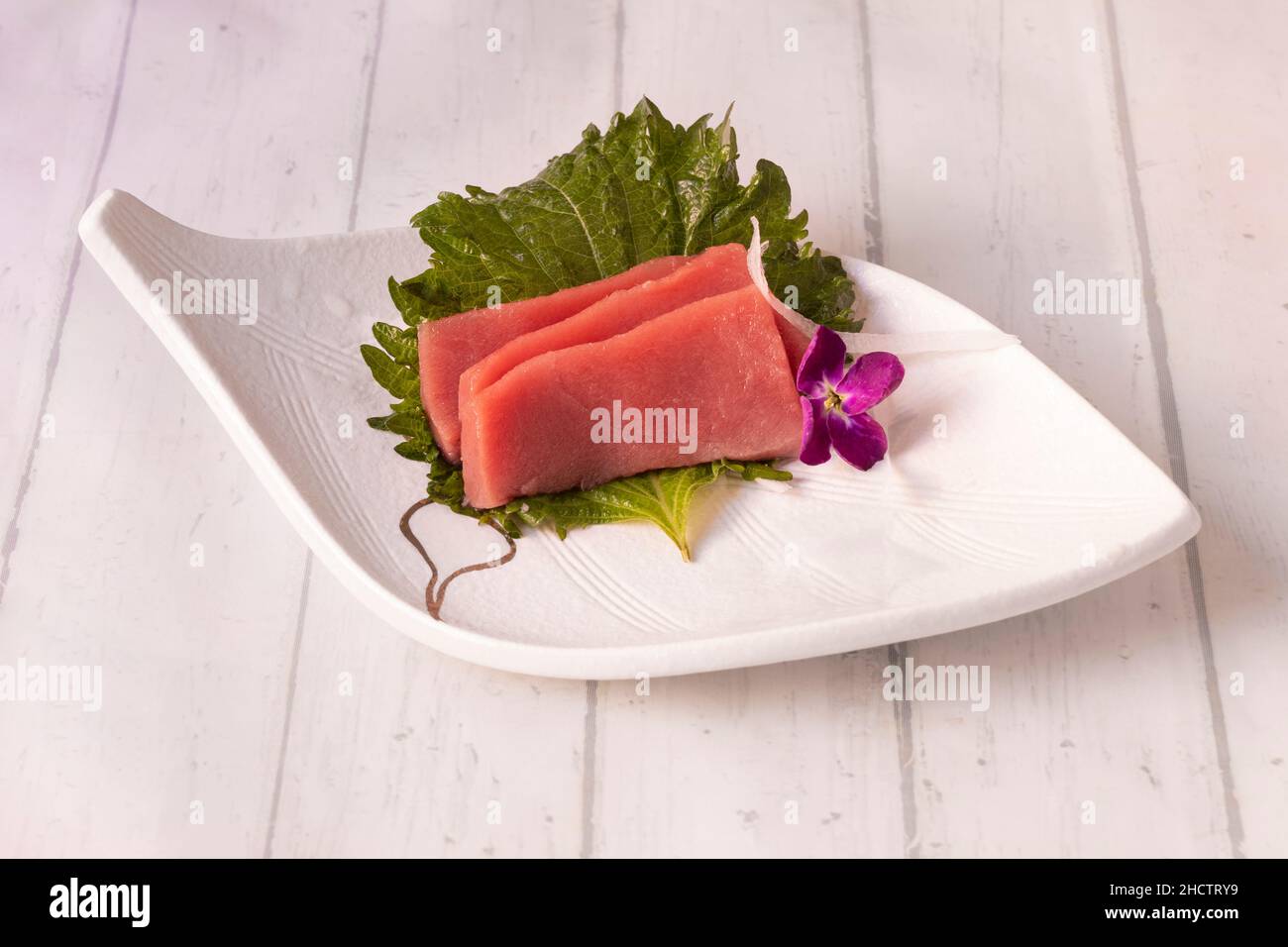 Sashimi is a Japanese dish that consists mainly of raw seafood or fish ...