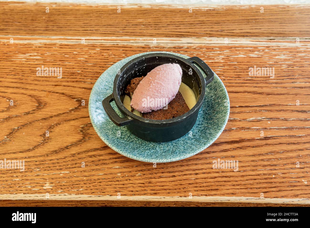 a piece of brownie with cherry ice cream quenelle Stock Photo - Alamy