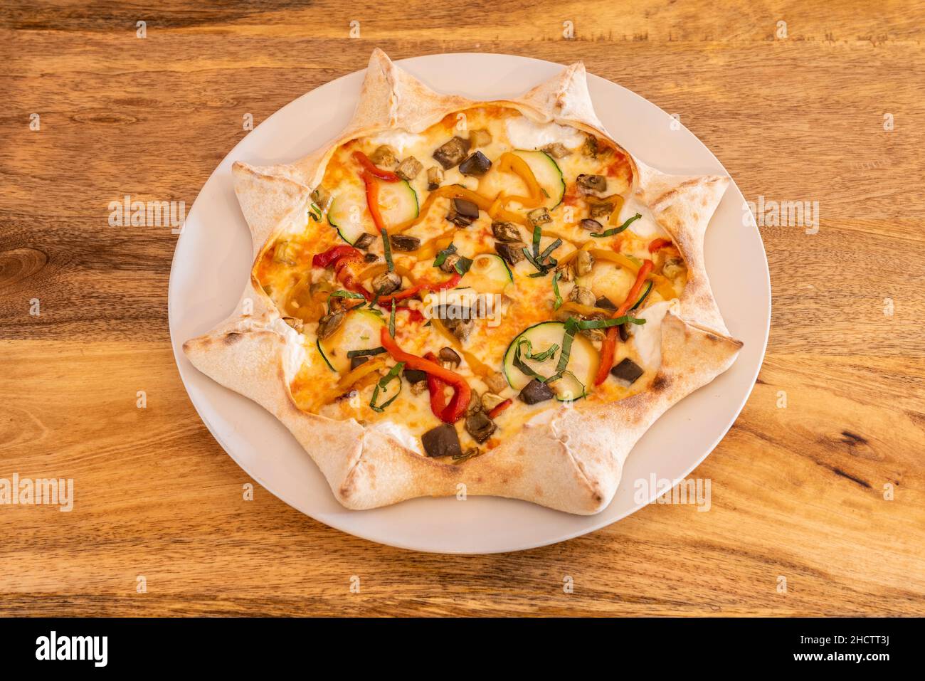 Star shaped pizza filled with fresh chopped vegetables and mozzarella ...