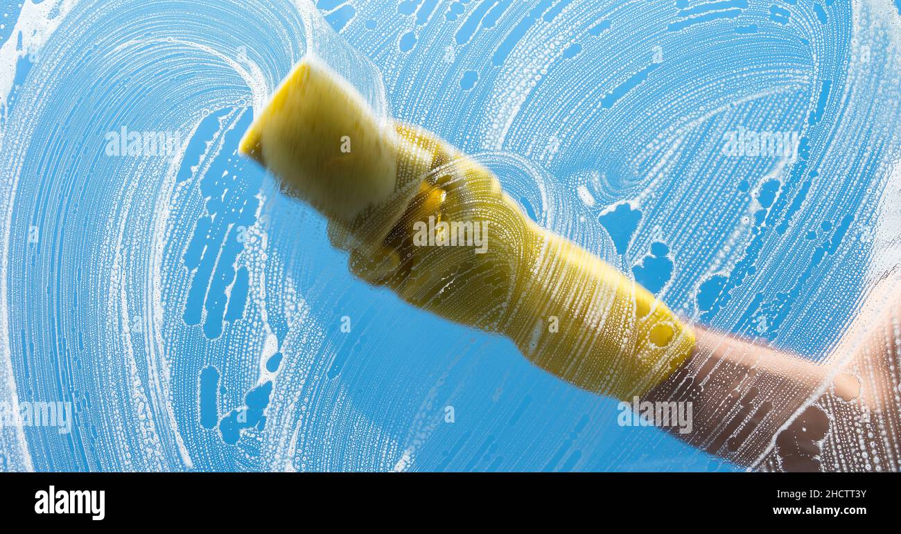 Washing window with soap, foam and sponge Stock Photo - Alamy
