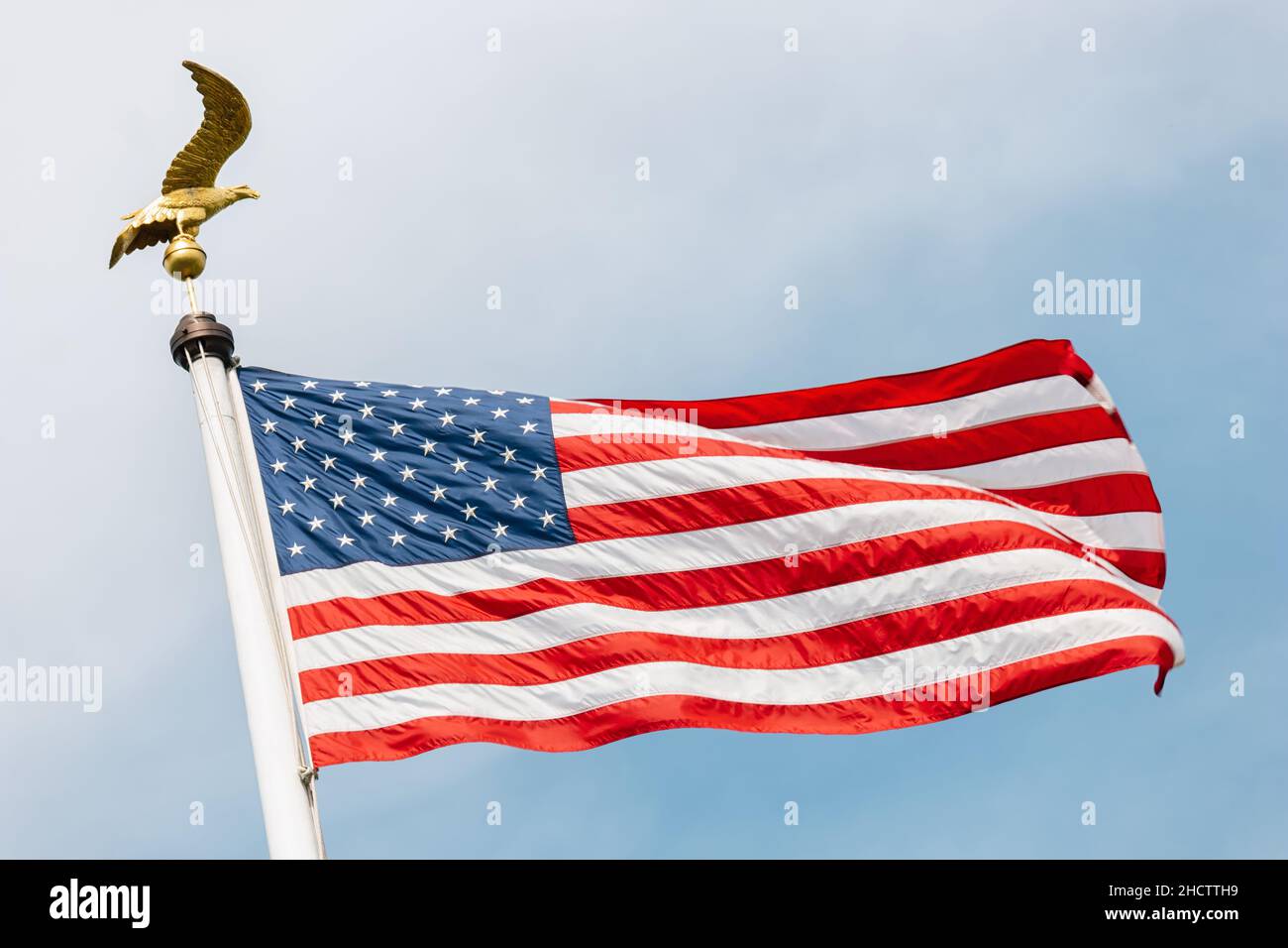 American flag with Bald Eagle - symbol of america - against blue sky ...