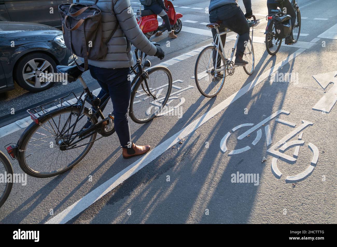 Cyclists wait at the traffic lights on the bike path Stock Photo - Alamy