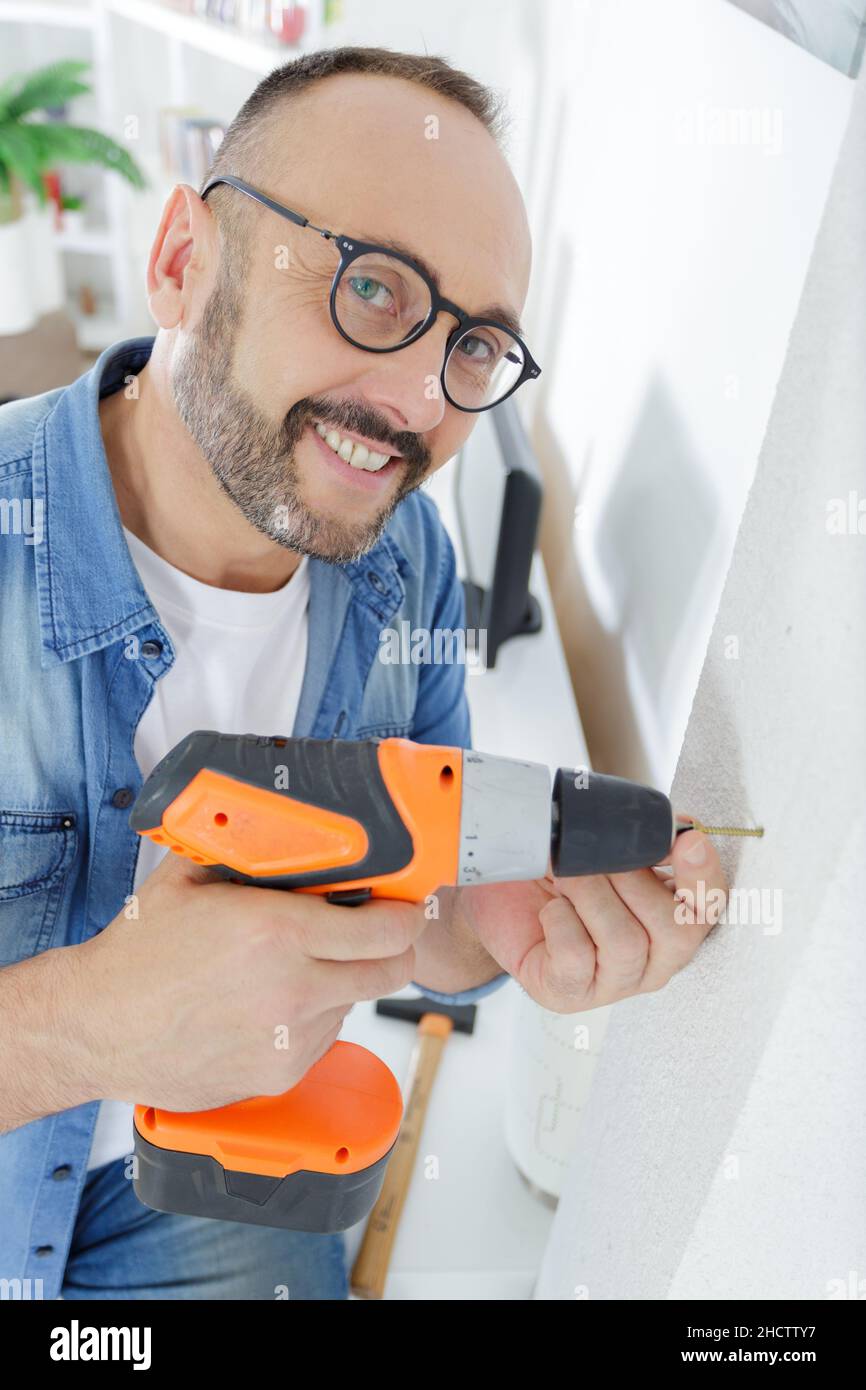 handsome man with cordless hand drill renovation Stock Photo - Alamy