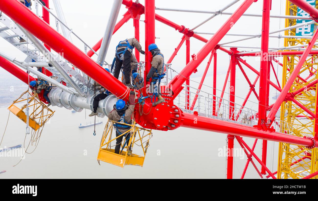 WUXI, CHINA - JANUARY 1, 2022 - Construction workers assemble the world's tallest power ...
