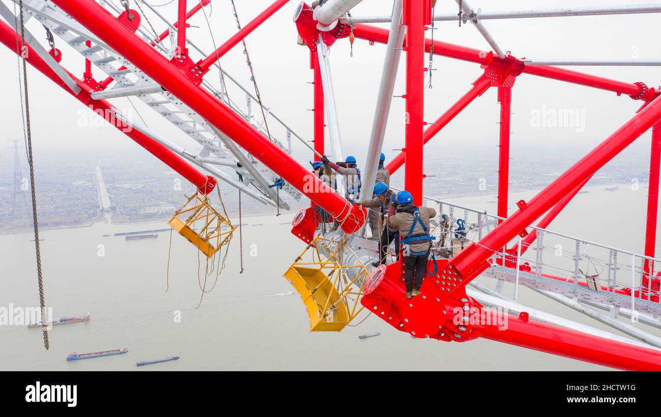 WUXI, CHINA - JANUARY 1, 2022 - Construction workers assemble the world's tallest power ...