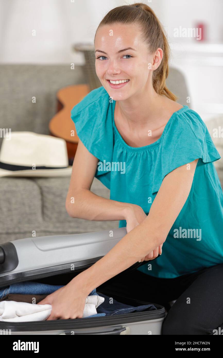 young lady at home packing her suitcase for travel Stock Photo - Alamy