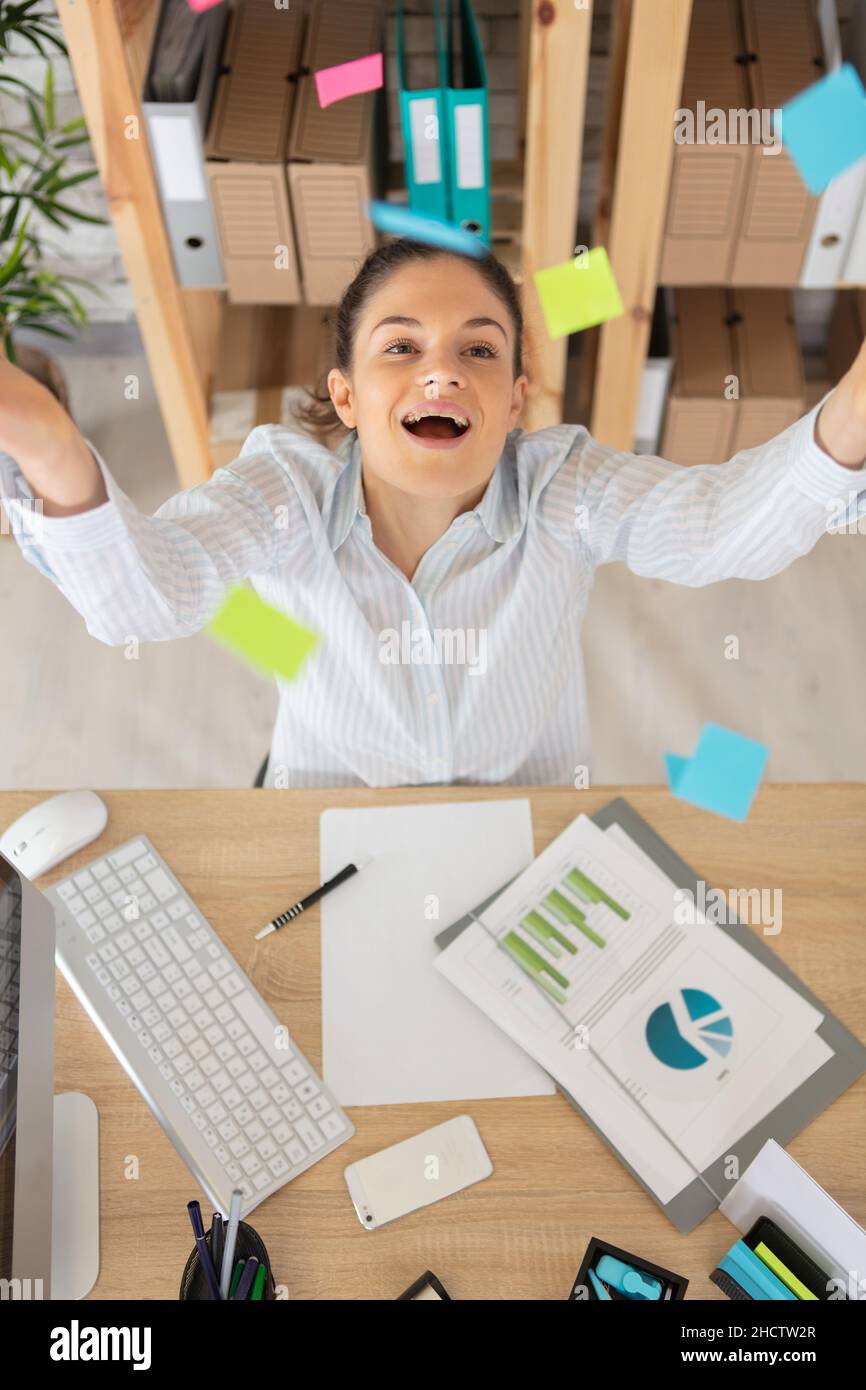 creative business woman throwing post it paper in the air Stock Photo ...