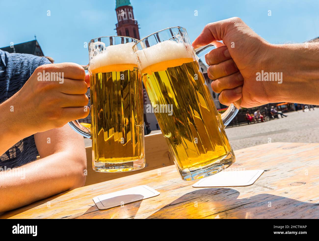 two human hands toast with glasses of german beer in Frankfurt Stock ...