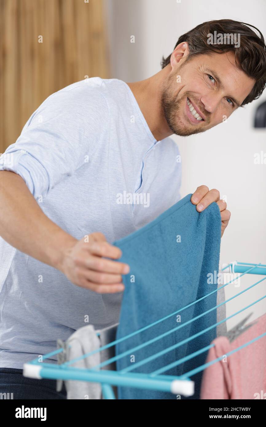 happy man drying clothes on drying Stock Photo - Alamy