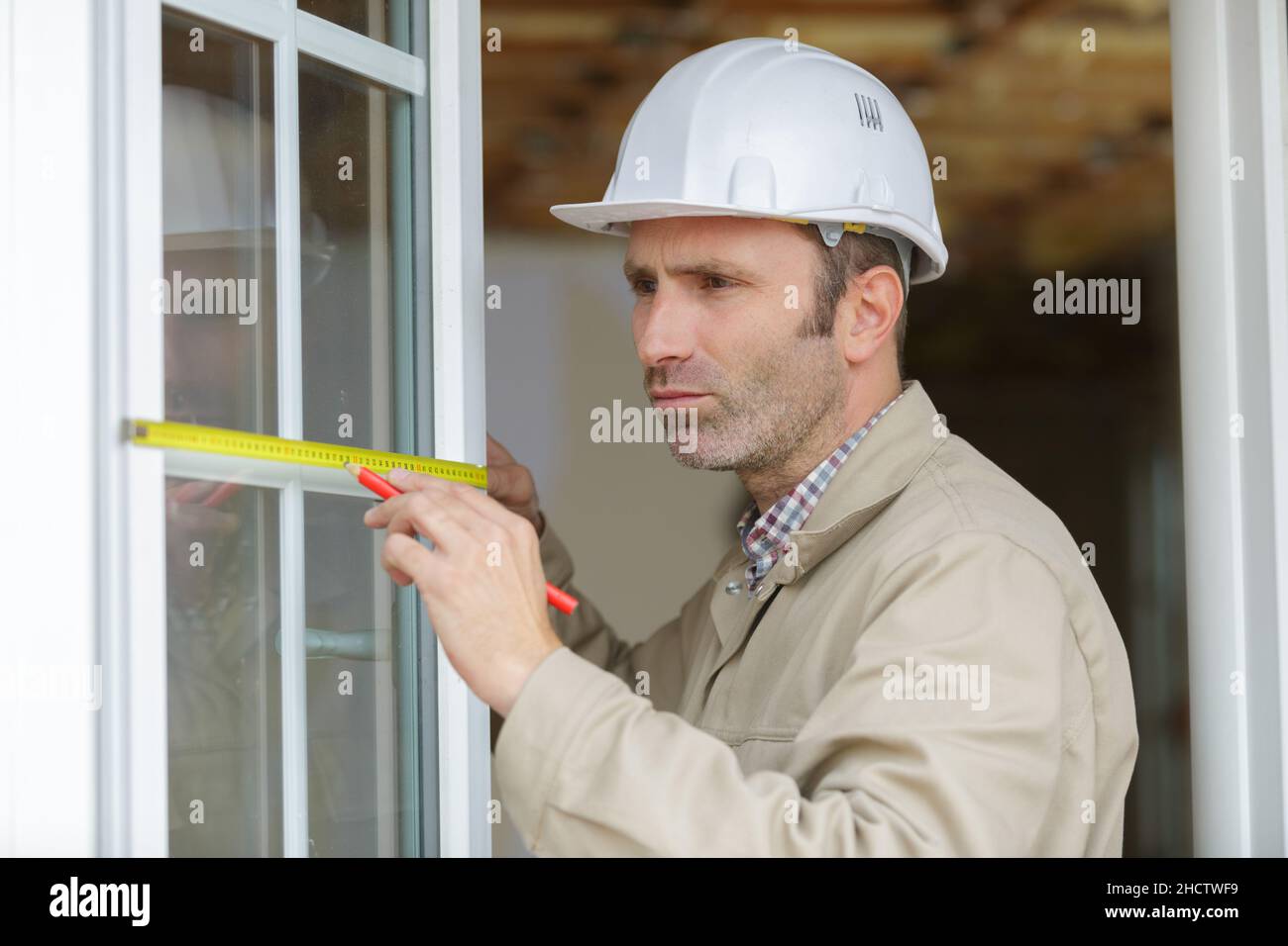 a man measuring a window Stock Photo - Alamy
