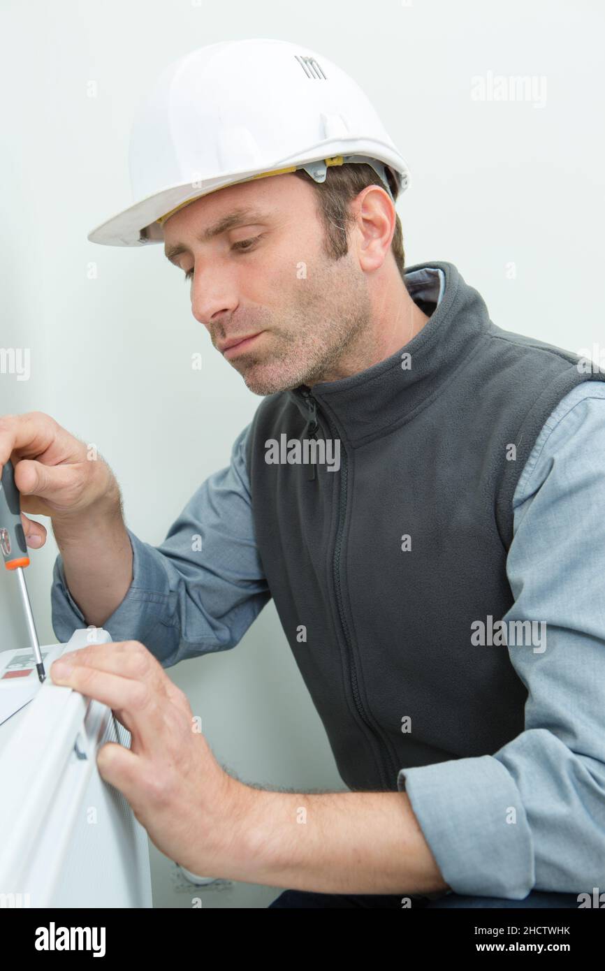 worker installing something in house Stock Photo - Alamy